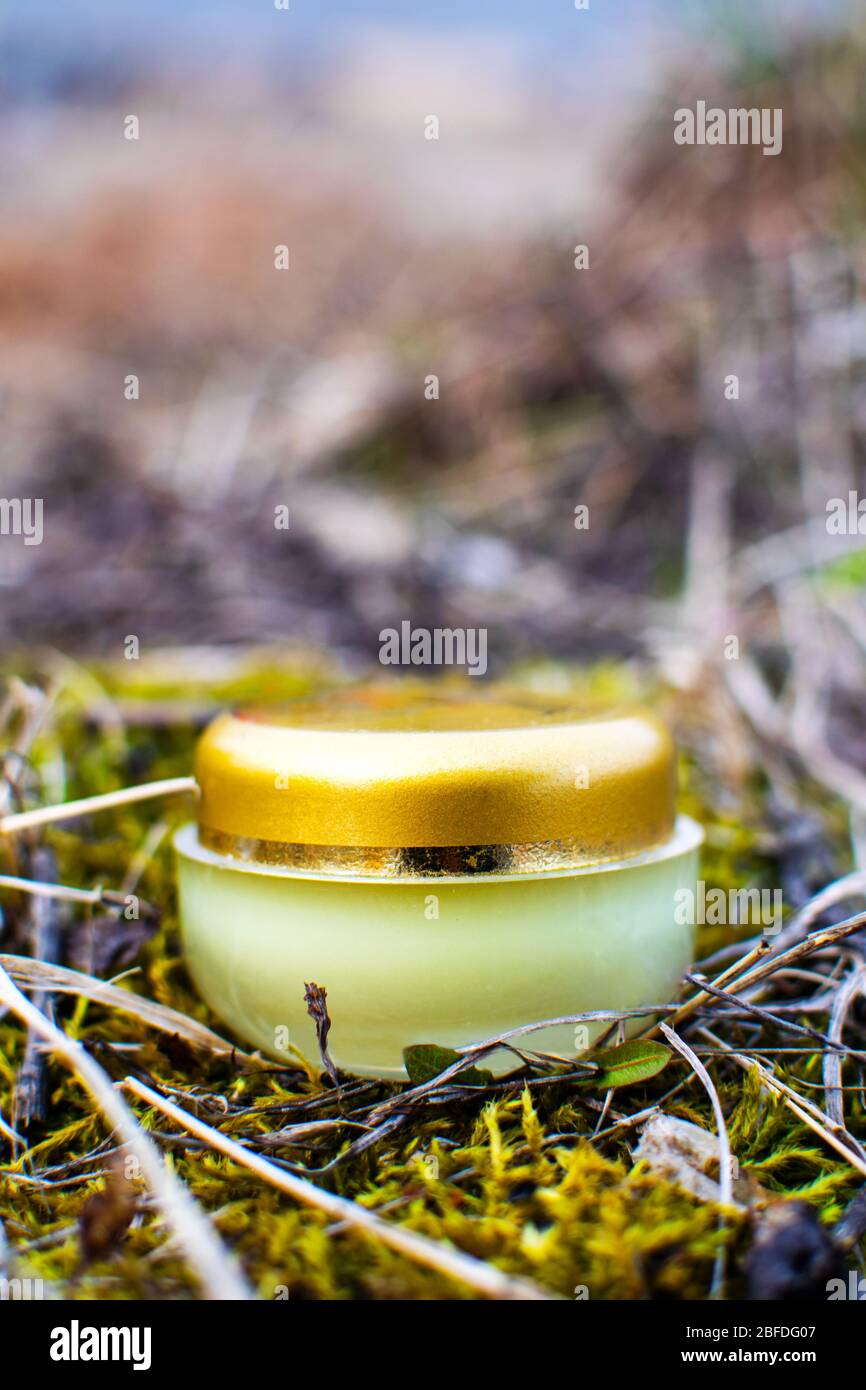 Cosmetic cream in a jar on a natural background. Natural ingredients ...