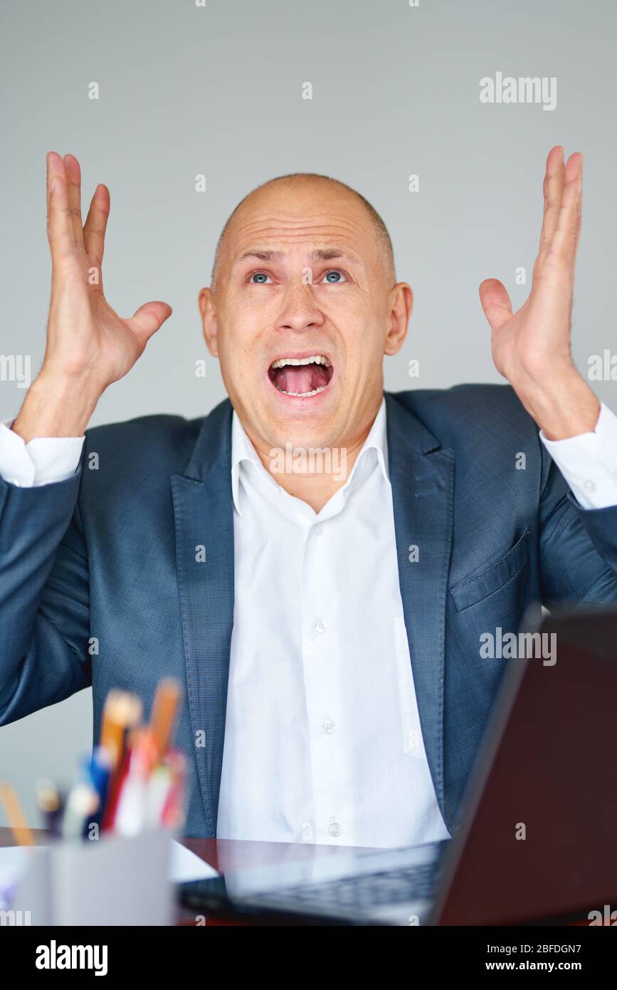 Man with problems and stress in the office. Office manager raising ...