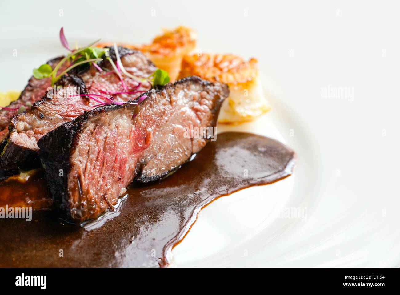 72hrs. seared beef short ribs served on white plate Stock Photo - Alamy