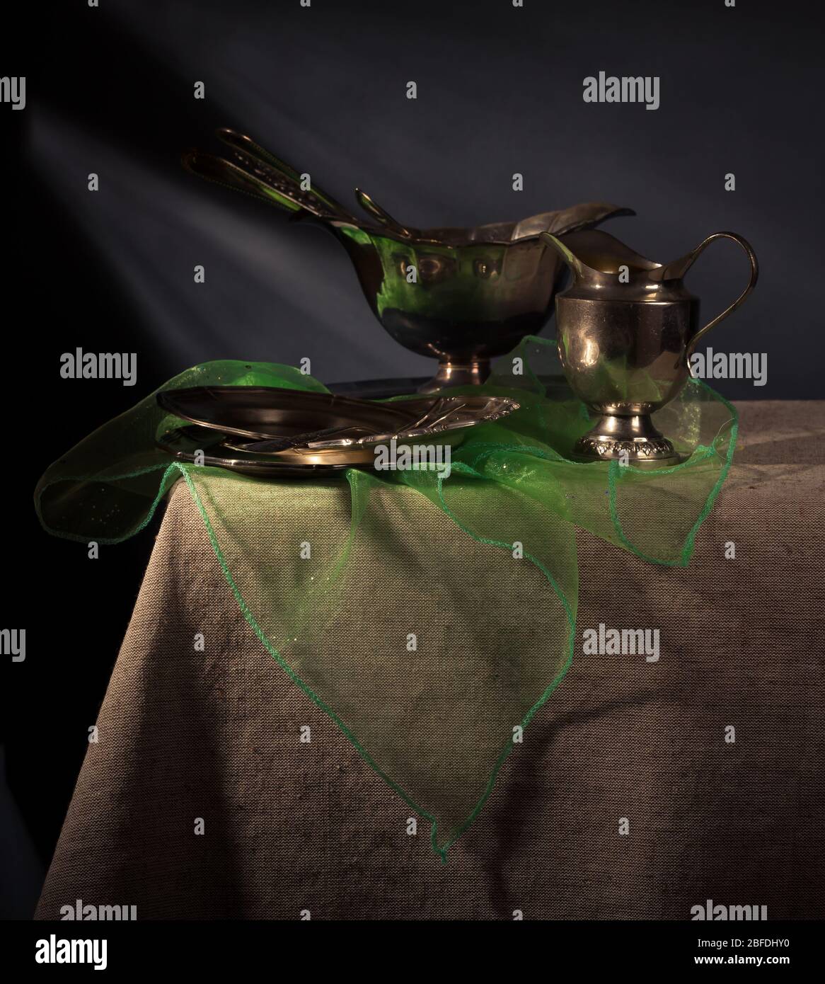 Traditional still life with old metal utensils and rays of light on a ...