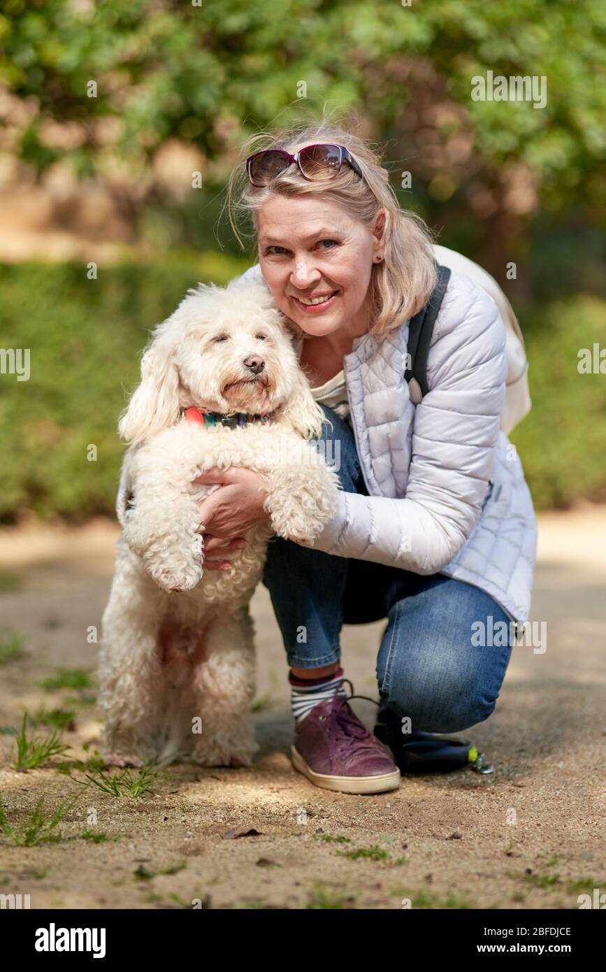 Middle aged female walking dog hi-res stock photography and images - Alamy