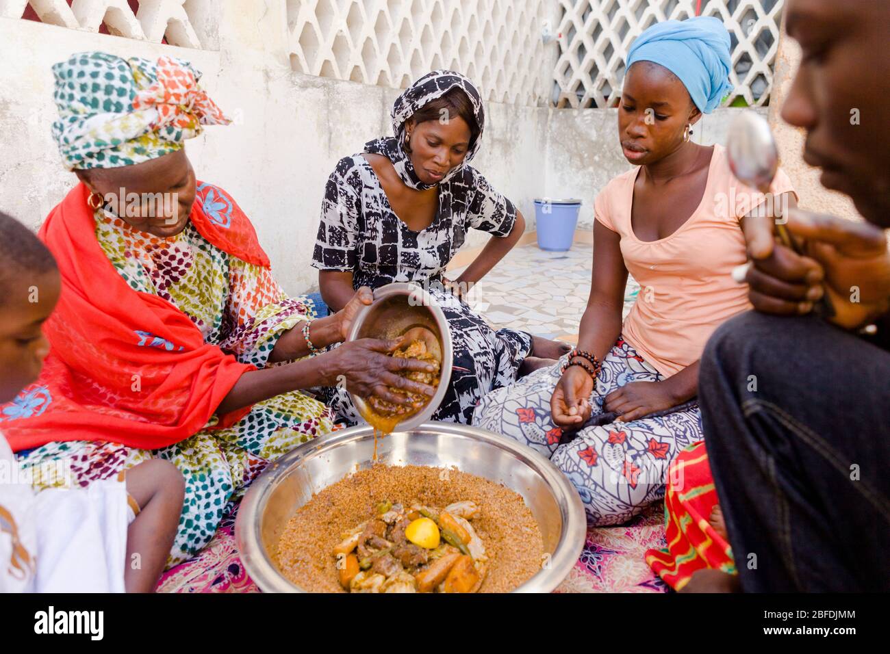 Mohammed Sovv's family preparing to eat Senegalese tiep bou djen (fried ...