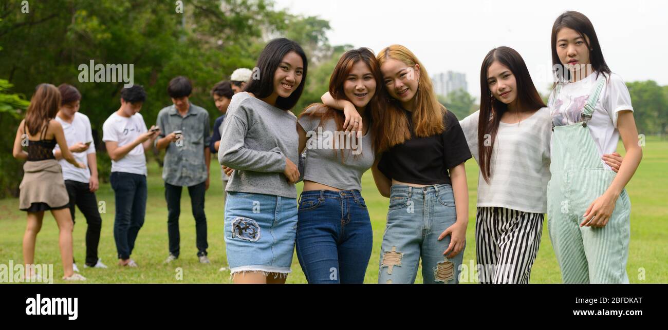 Happy young group of friends hanging out together at the park Stock ...