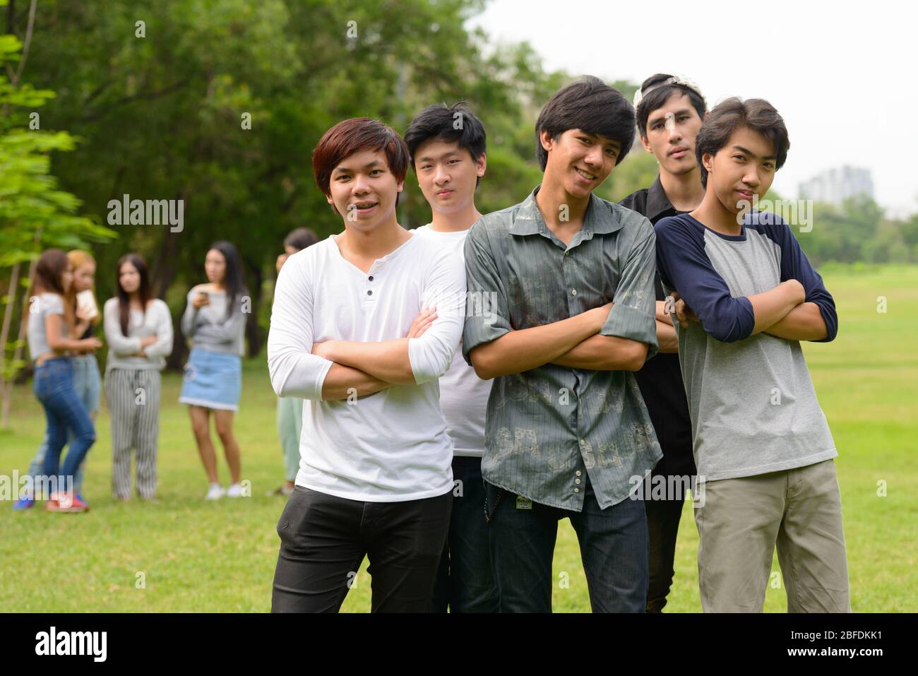Happy young group of friends hanging out together at the park Stock ...