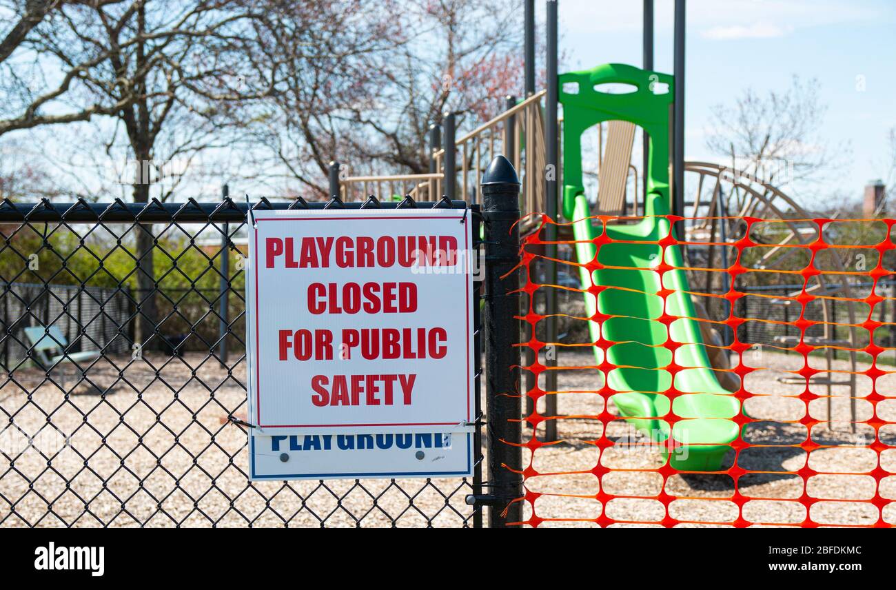 Playground closed for public safety sign posted on the fence of a play ...