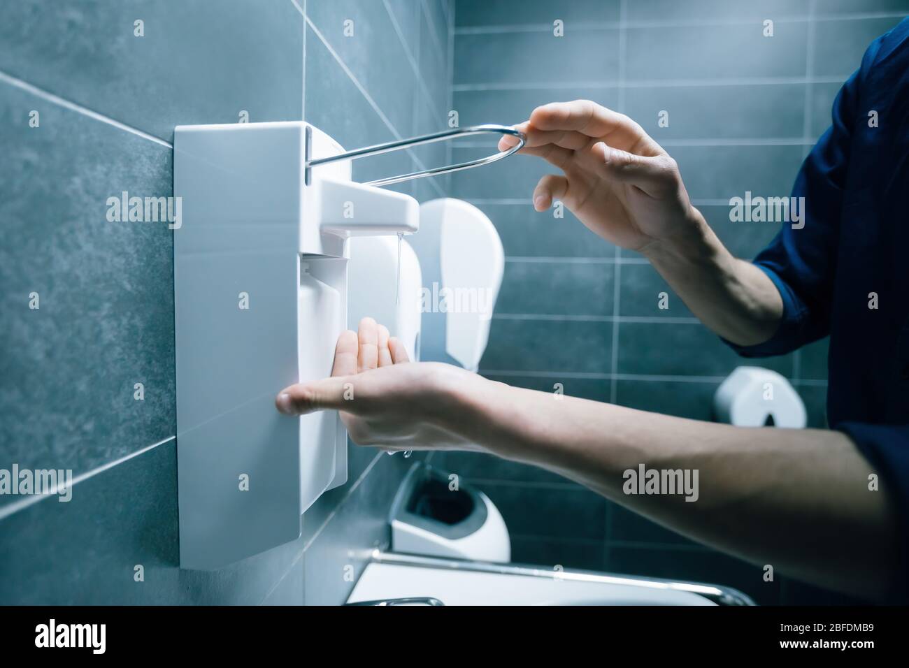 close up. young man pushing a dispenser with bactericidal soap Stock ...