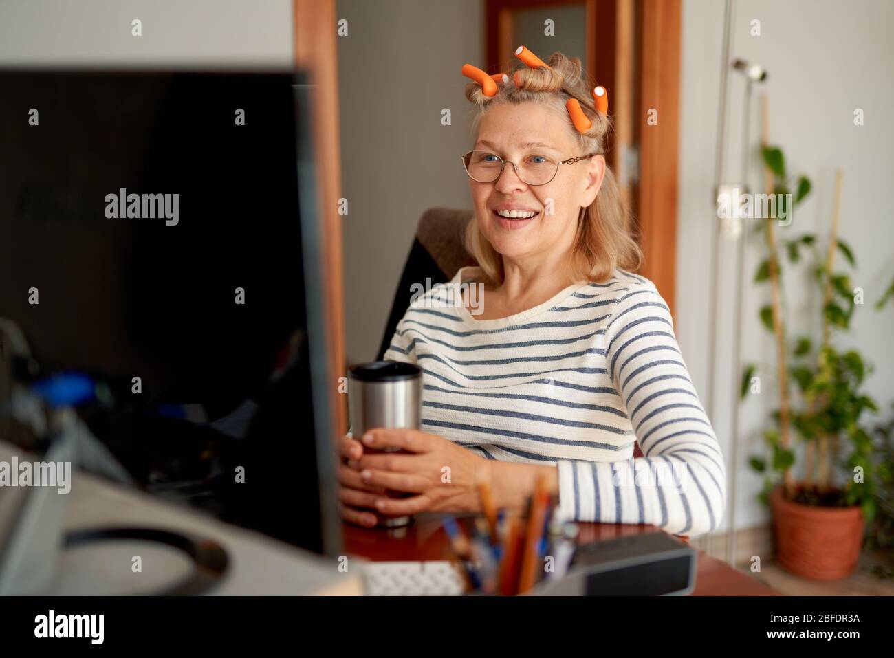 Happy woman resting looking at monitor screen Stock Photo - Alamy