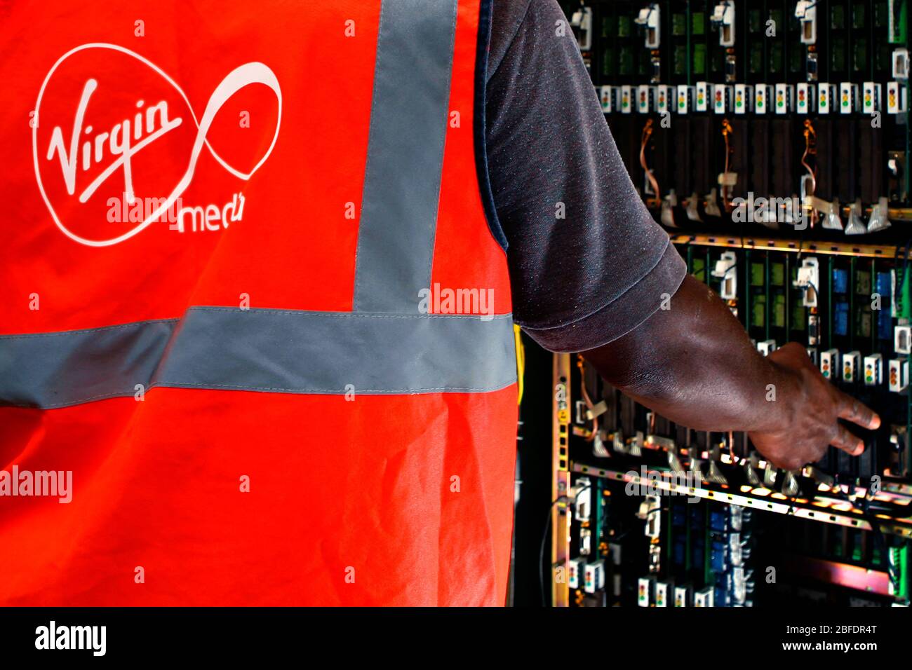 A Virgin Media engineer connecting a house to the Virgin telephone ...