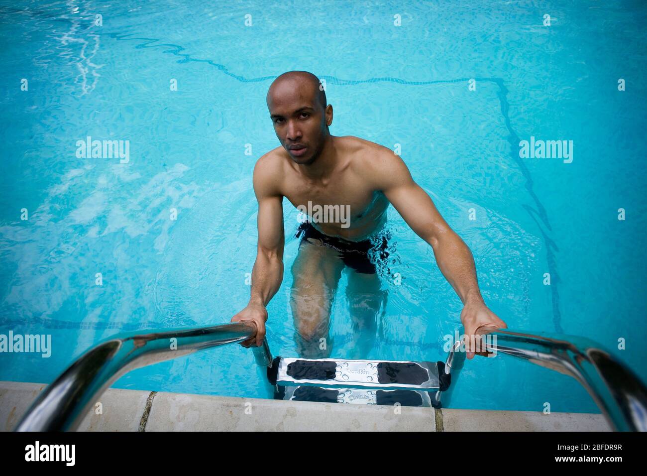 Climbing out of swimming pool hi-res stock photography and images - Alamy