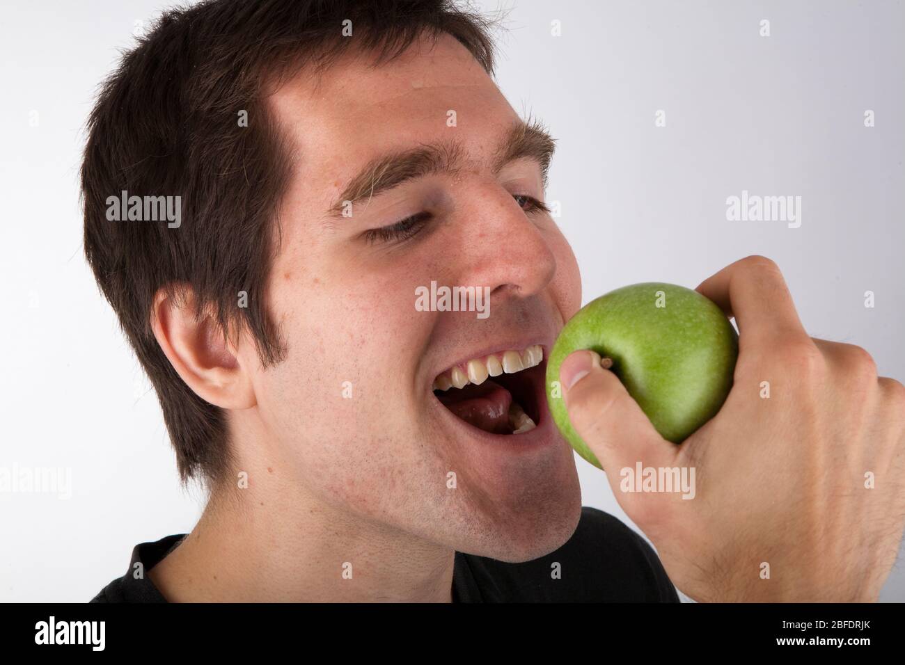 Man eating an apple -Model Released Stock Photo - Alamy