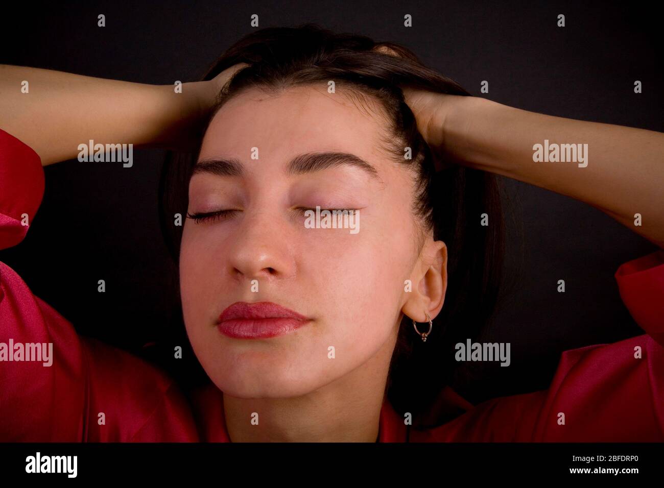 Woman running her hands through her hair. -Model Released Stock Photo ...