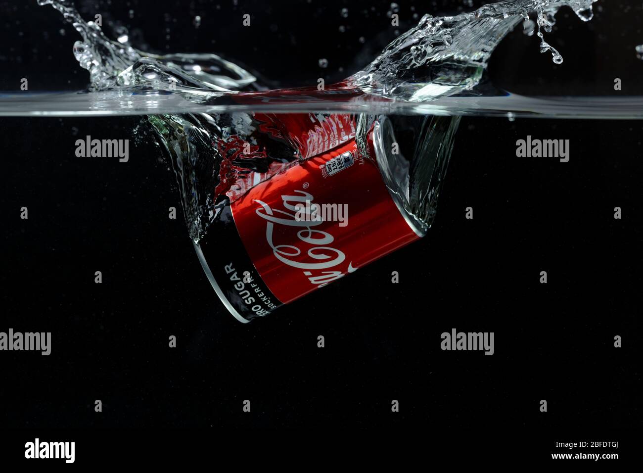 Close up view of can falling in water. Coca cola Stock Photo - Alamy