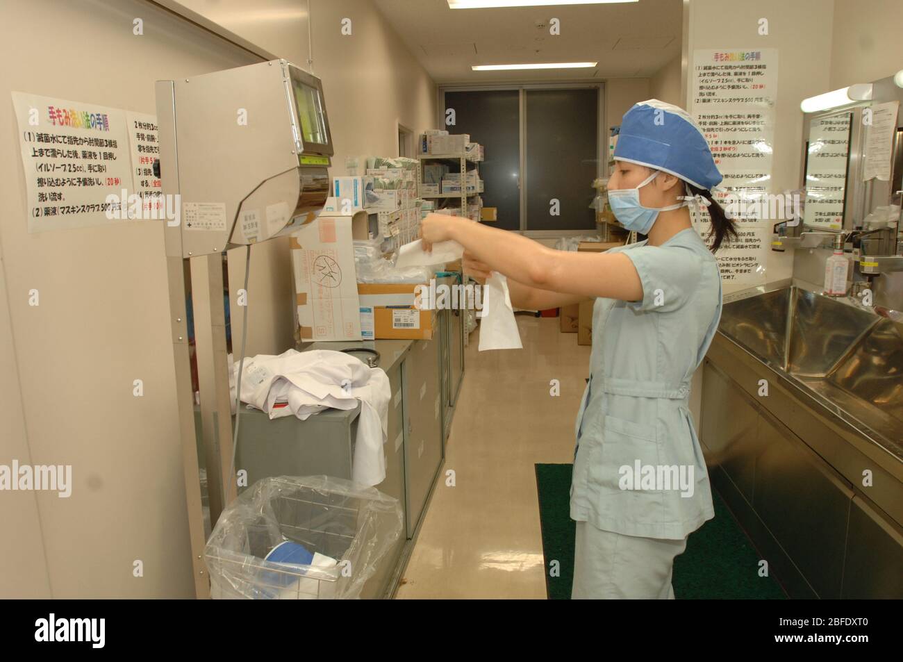 Nurse scrubbing up prior to consulting with a patient, Japanese Red ...