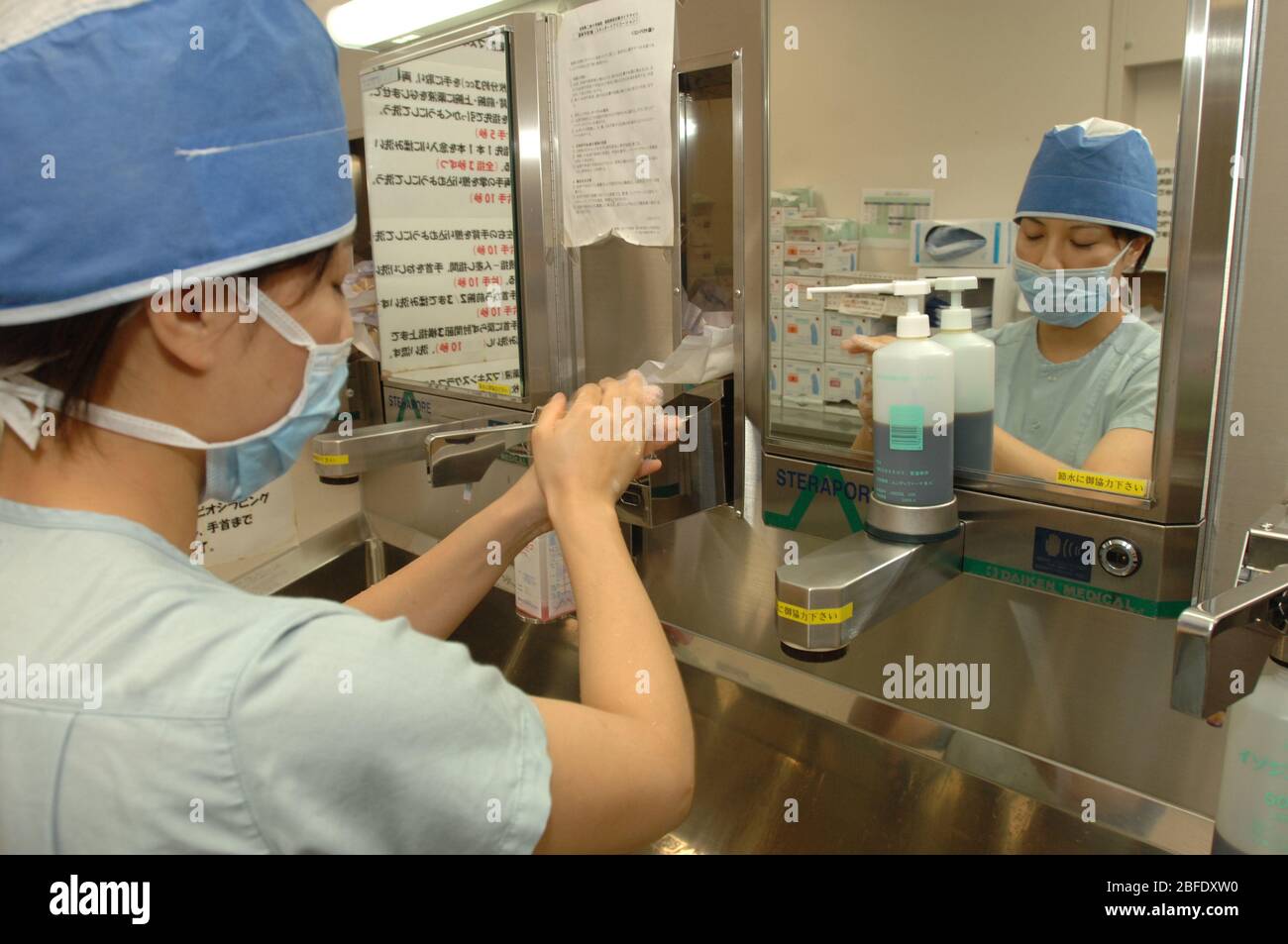 Nurse scrubbing up prior to consulting with a patient, Japanese Red ...