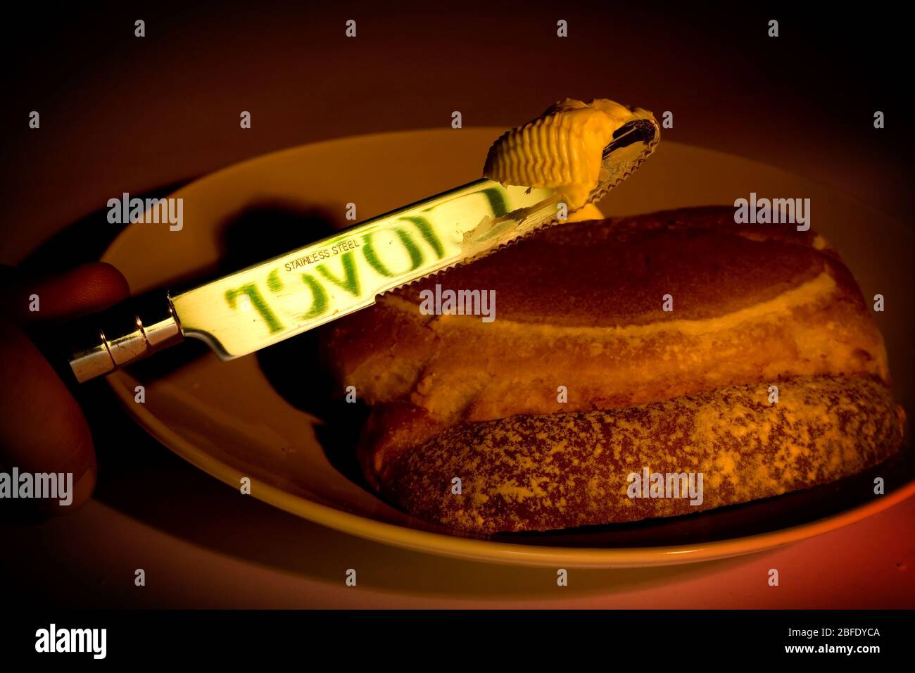 A man spreading Clover butter on bread Stock Photo - Alamy