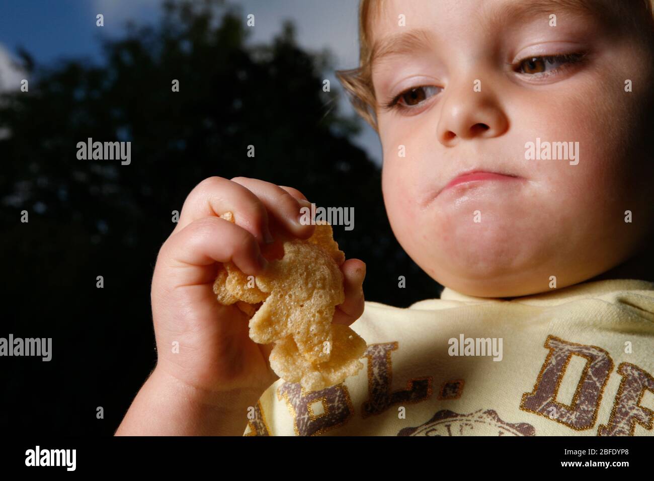 A Young Child with a popular potato crisp Stock Photo - Alamy