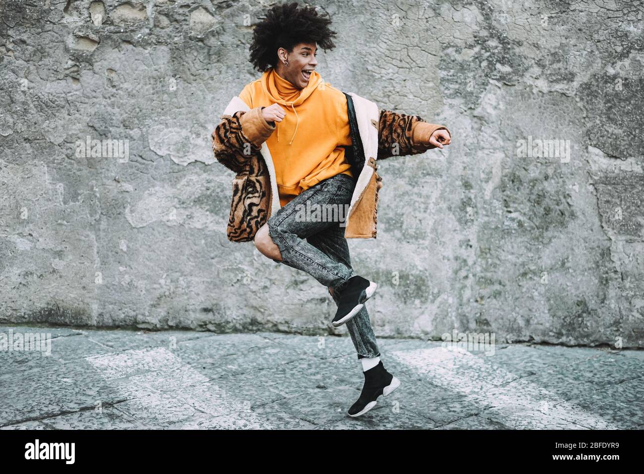Stylish millennial guy dancing around city street outdoor - Young man ...