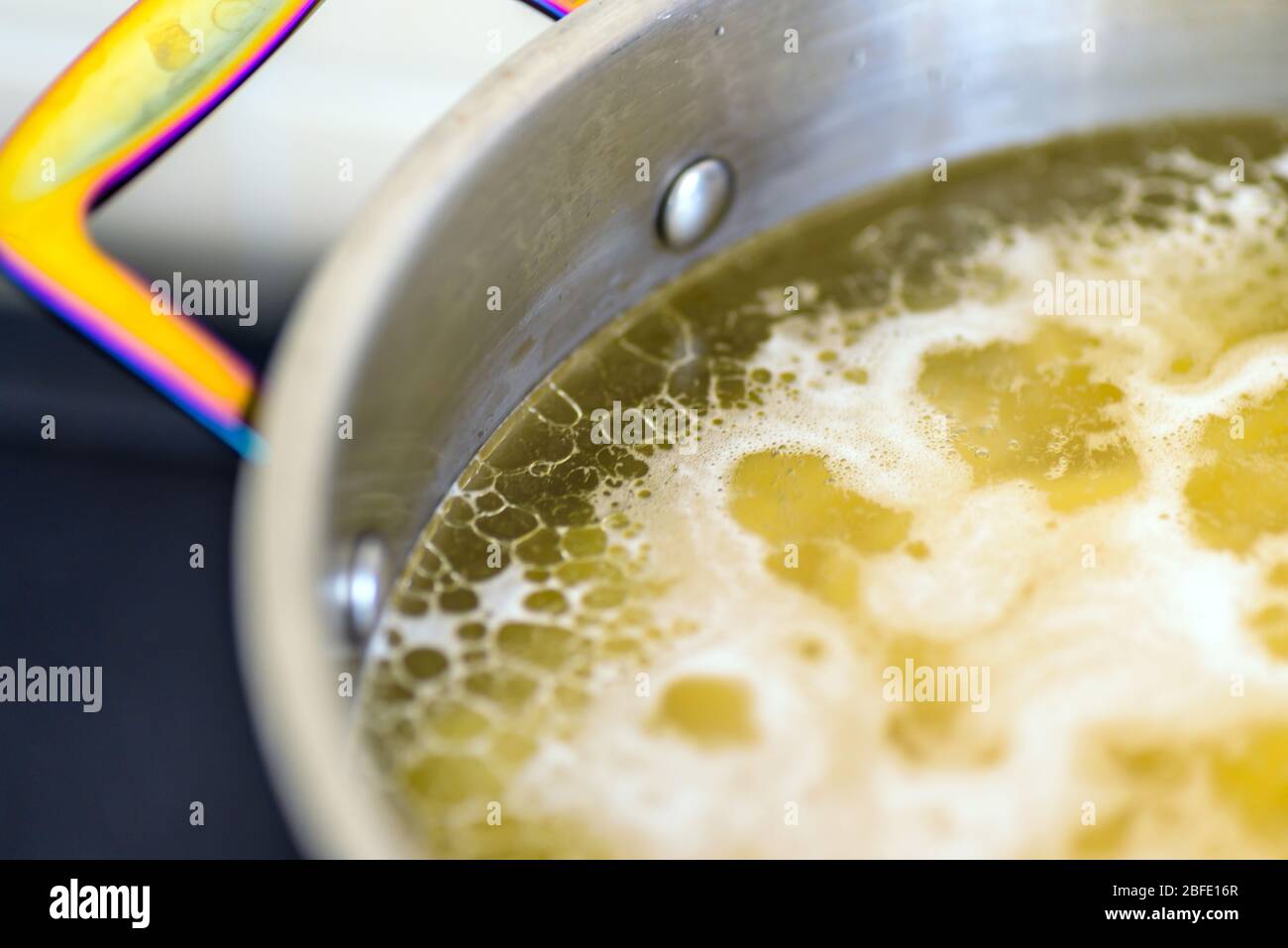 italian penne rigate macaroni pasta cooking inside large pan caserole ...