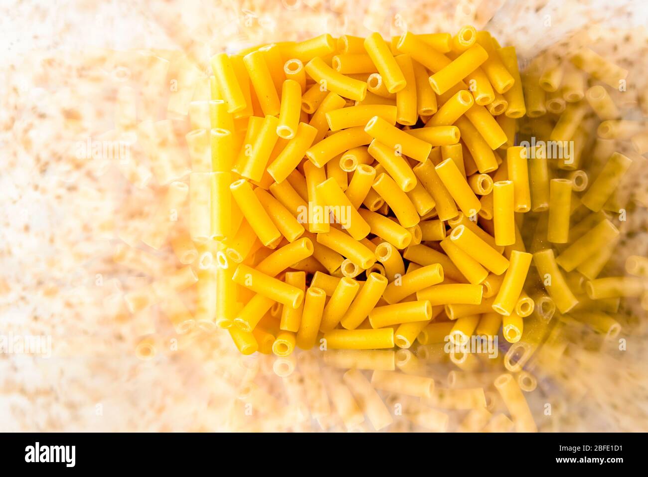 raw italian macaroni pasta inside clear storage container Stock Photo ...