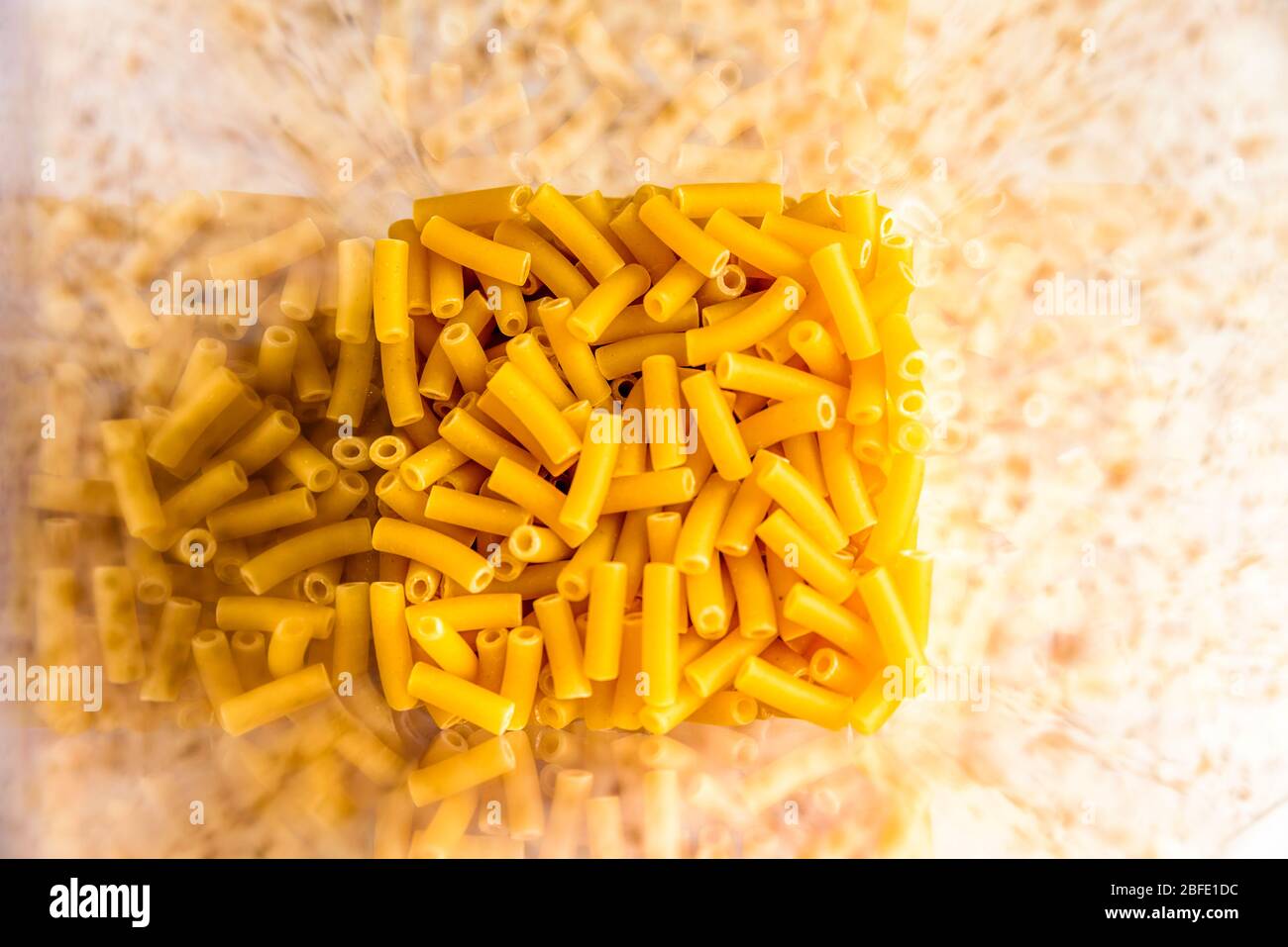 raw italian macaroni pasta inside clear storage container Stock Photo ...