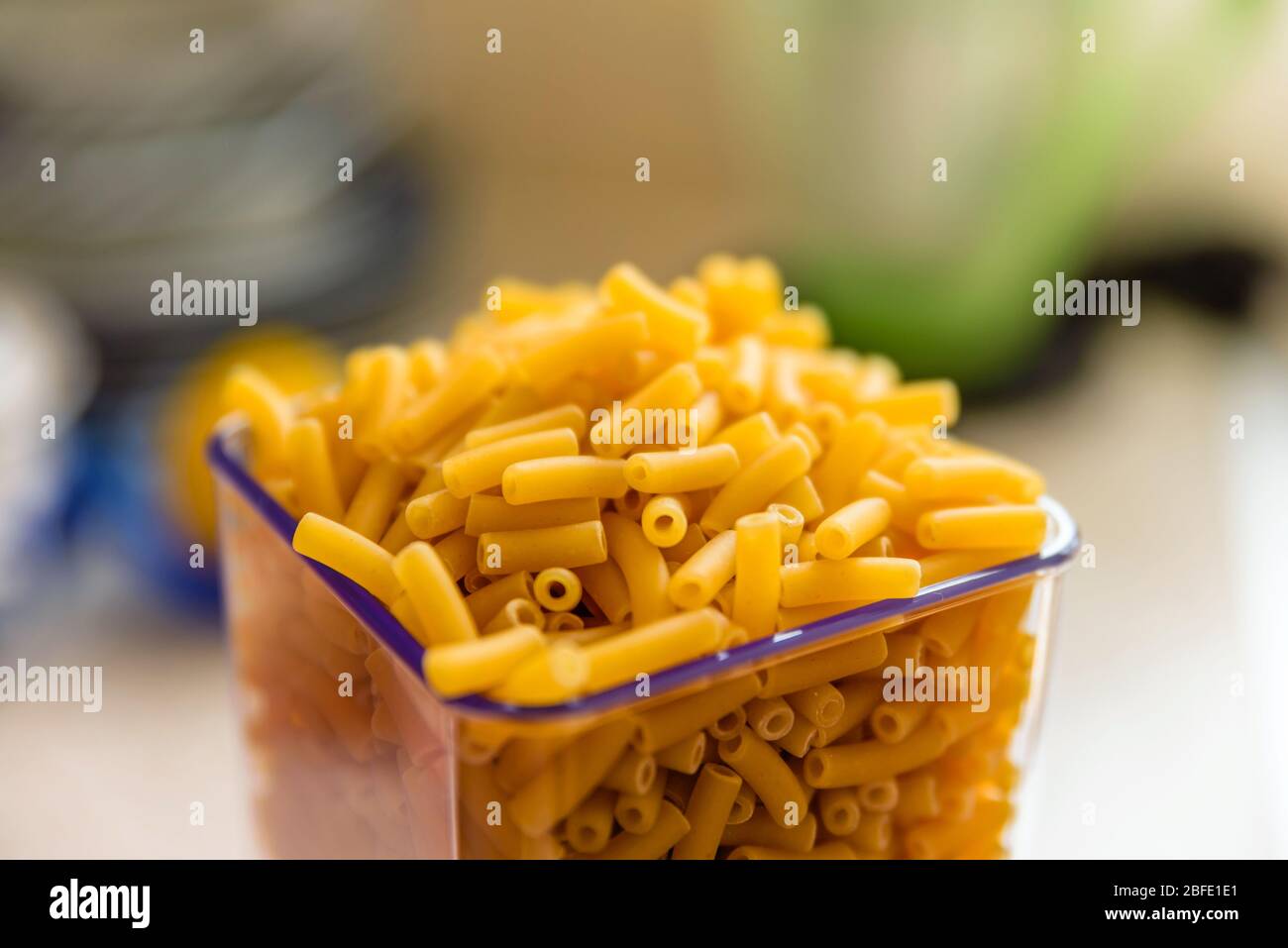 raw italian macaroni pasta inside clear storage container Stock Photo ...