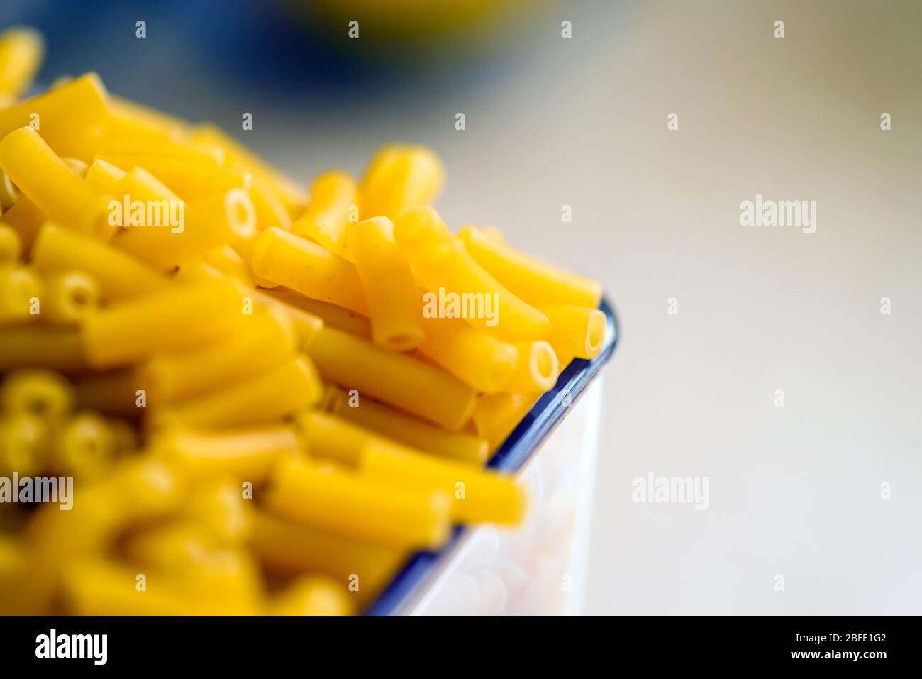 raw italian macaroni pasta inside clear storage container Stock Photo ...