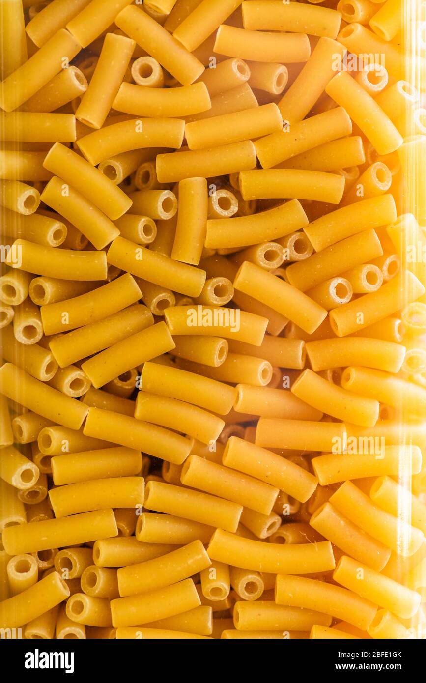 raw italian macaroni pasta inside clear storage container Stock Photo ...