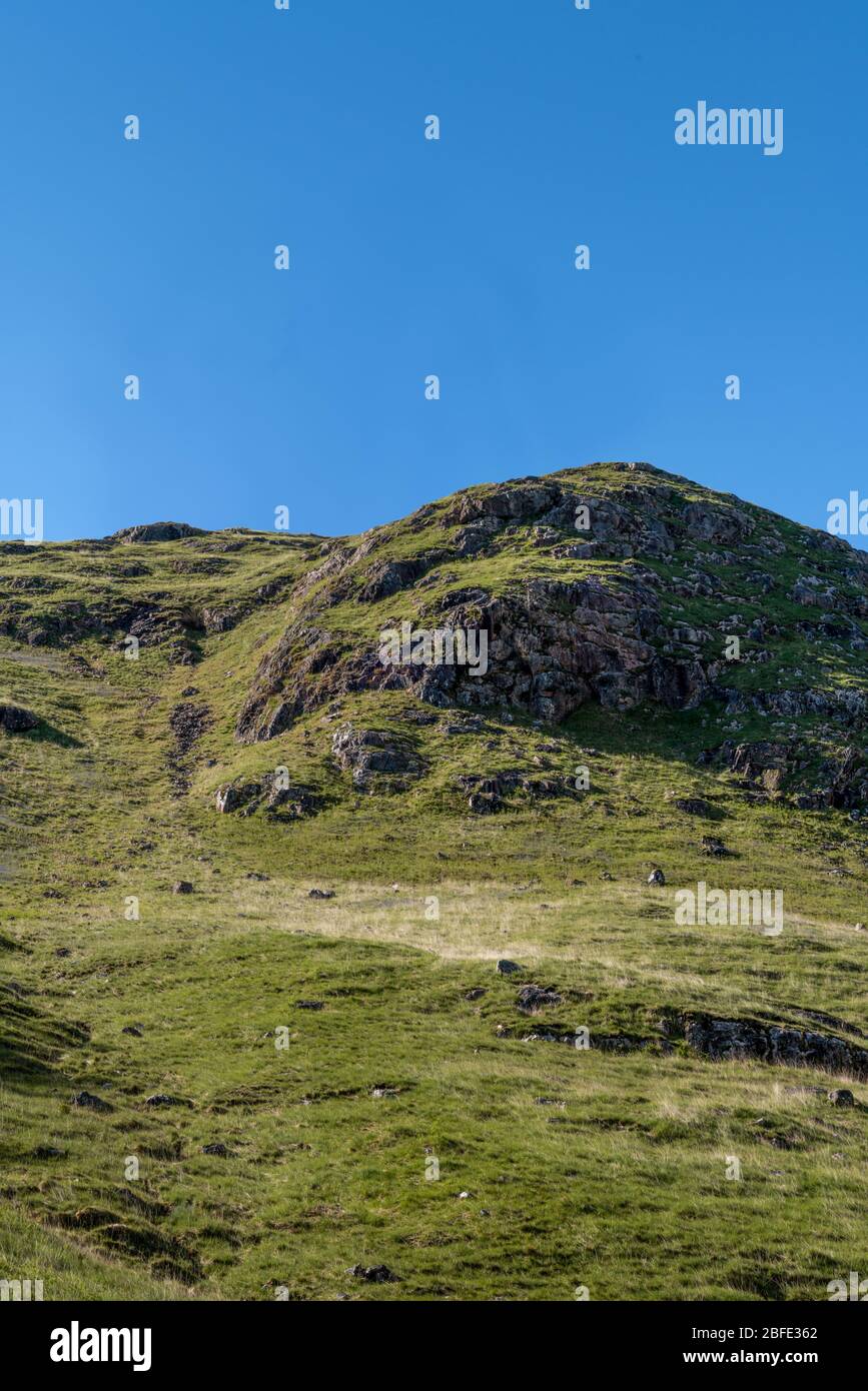 Face-on view looking up a green rocky Scottish highland hillside with ...