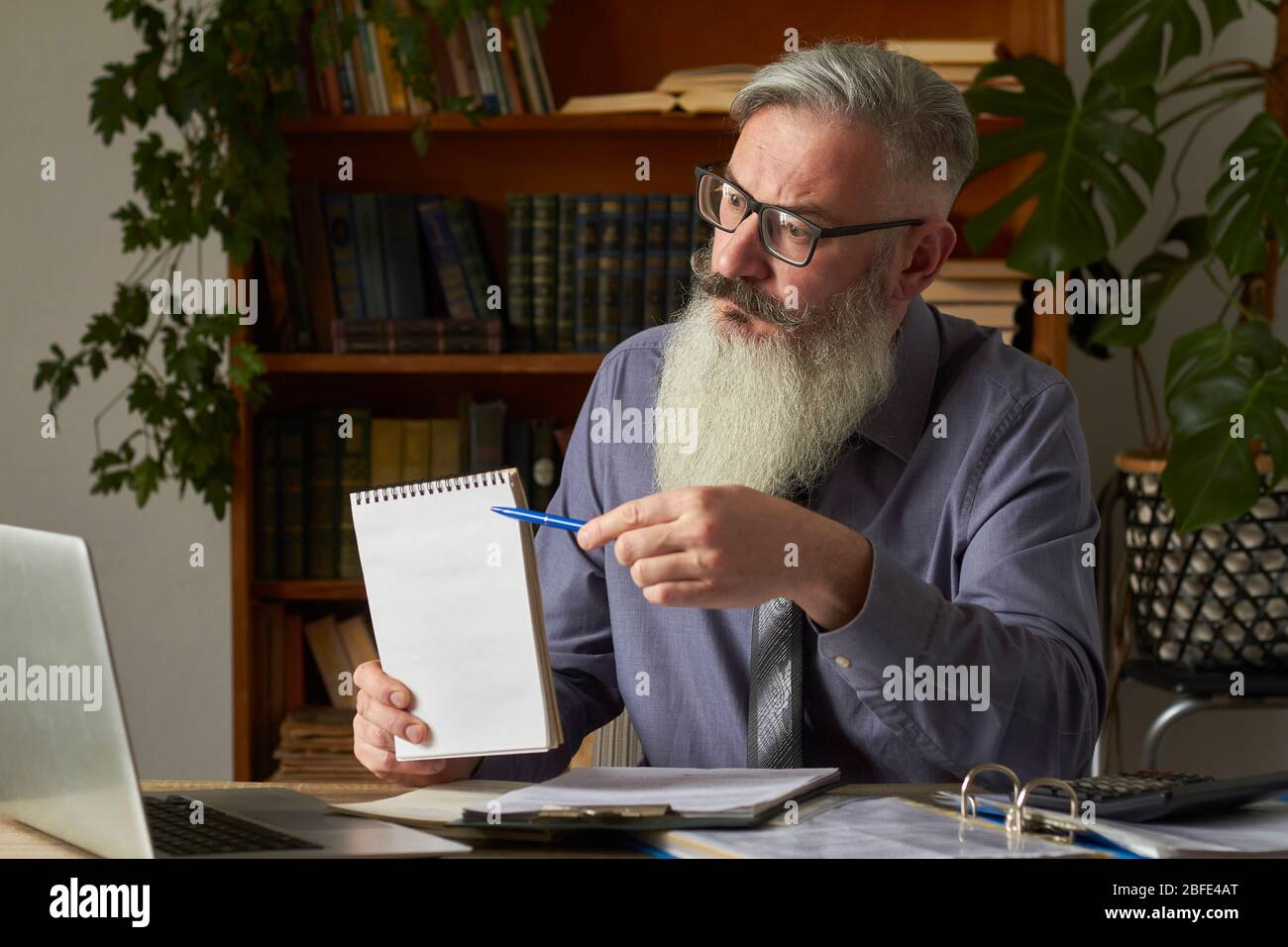 Concept of distance learning. Teacher, translator, tutor at the desktop ...