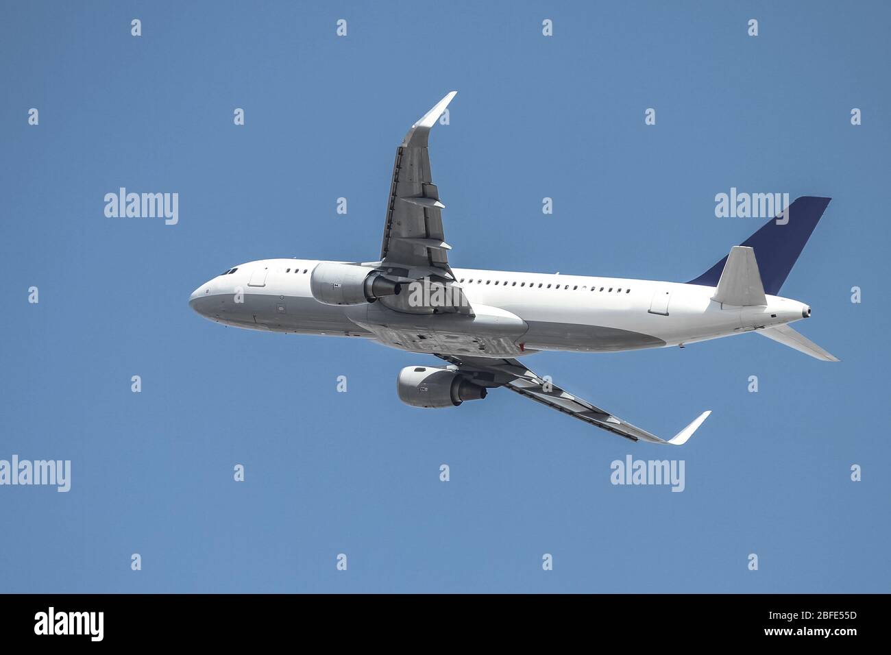 Passenger Airplane in the Sky with Blue Background Stock Photo - Alamy