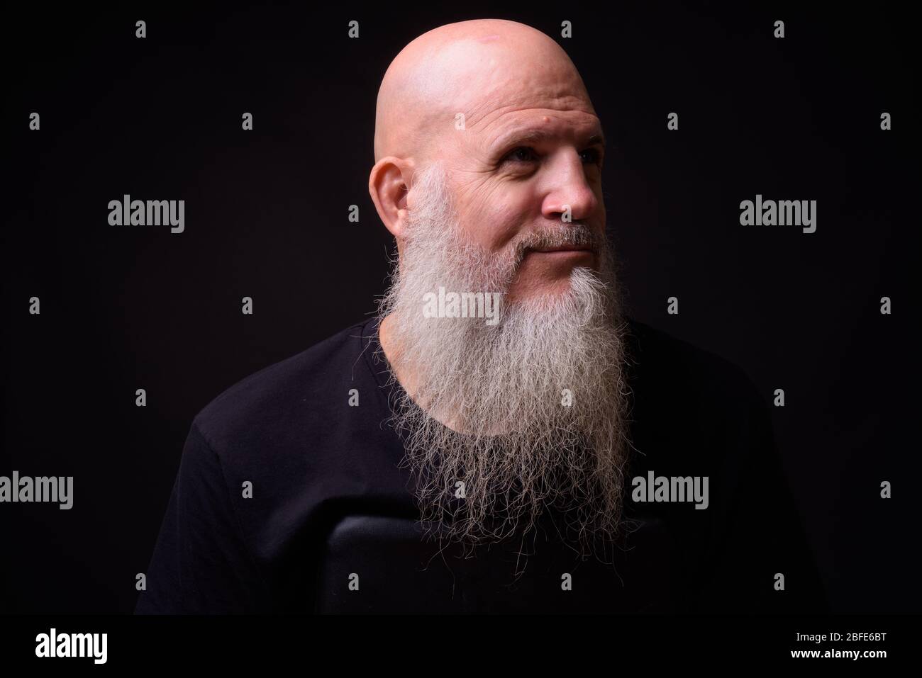 Happy mature bald man thinking hi-res stock photography and images - Alamy