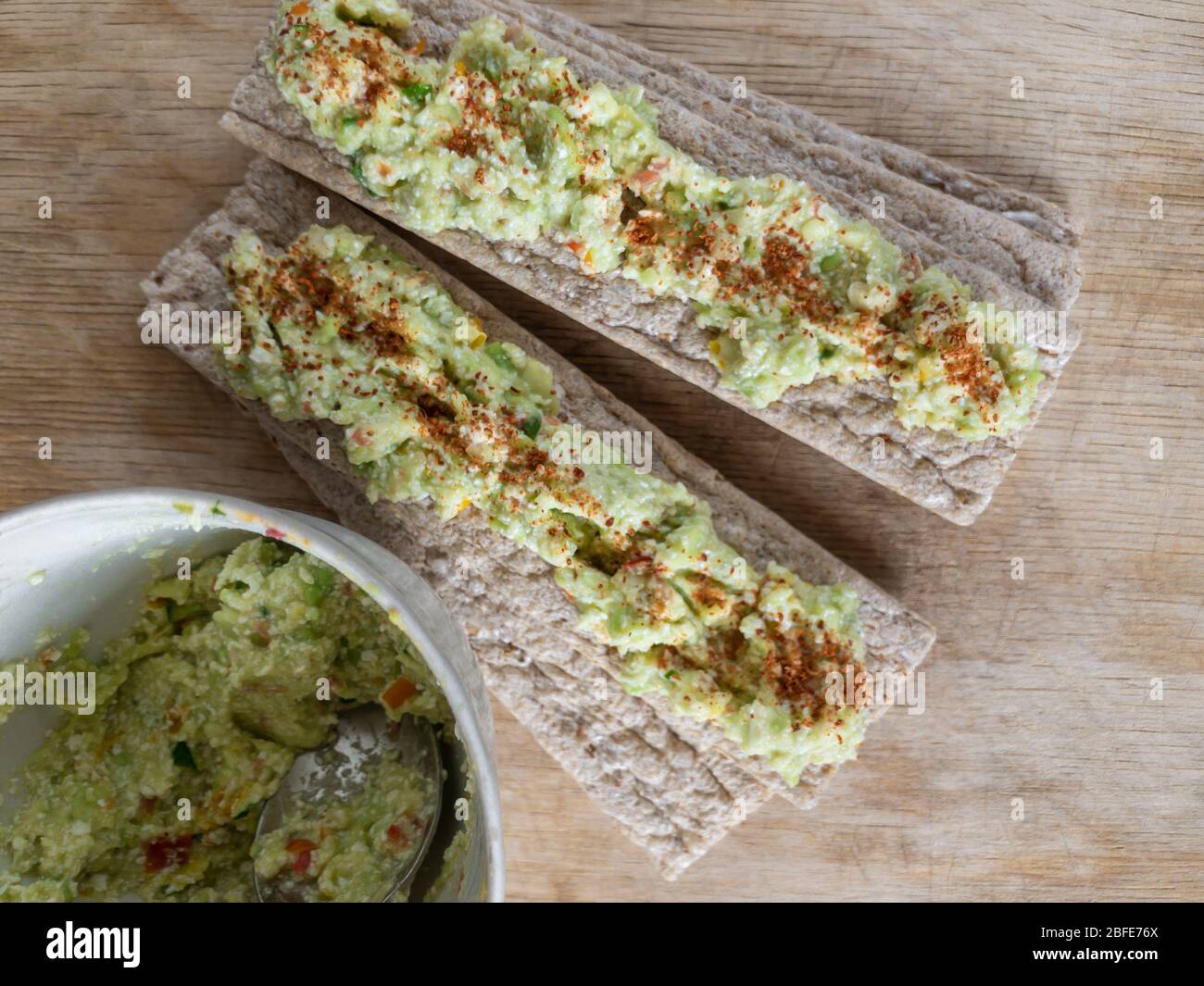 Top view on wooden table where located round container with guacamole ...