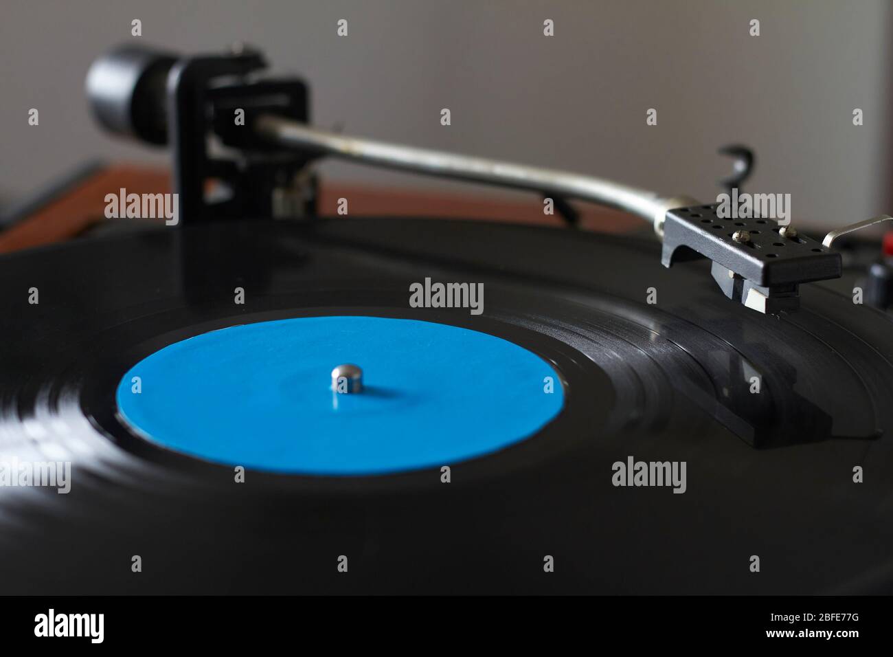 Close-up of blue music record on turntable, turntable needle playing ...