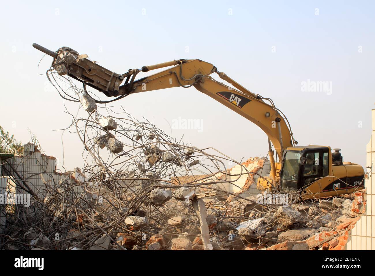 excavator is working in the construction debris clean up site in China ...