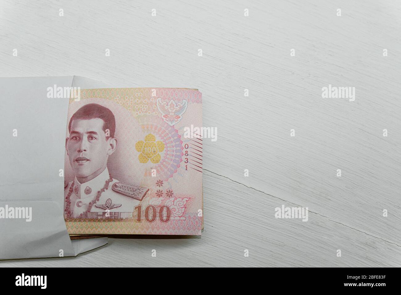 Thai Banknote 100 baht in a White envelope on a white table, Concept of ...