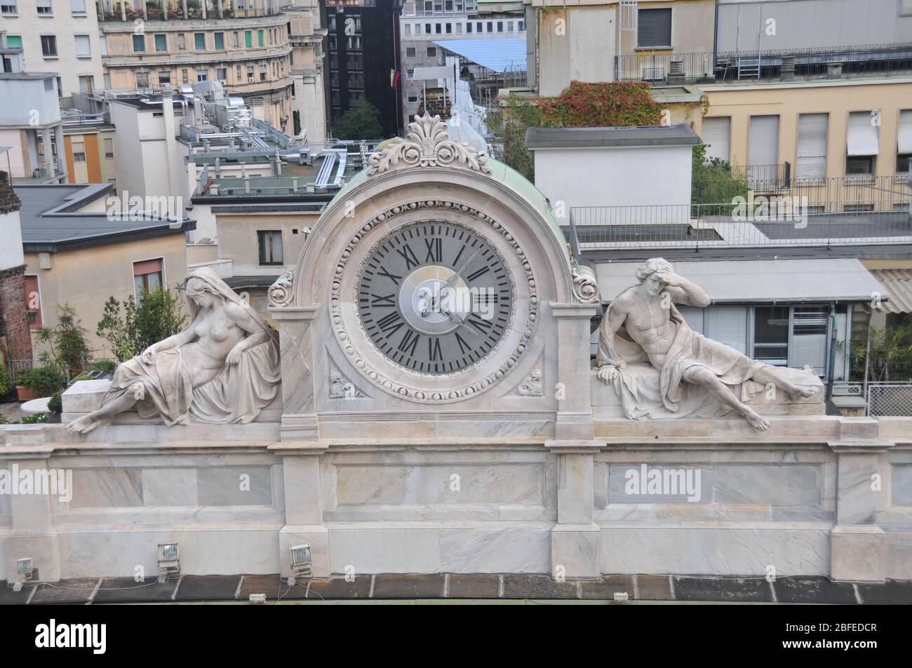 Around Italy - A clock face on a building to the rear of the Duomo in ...