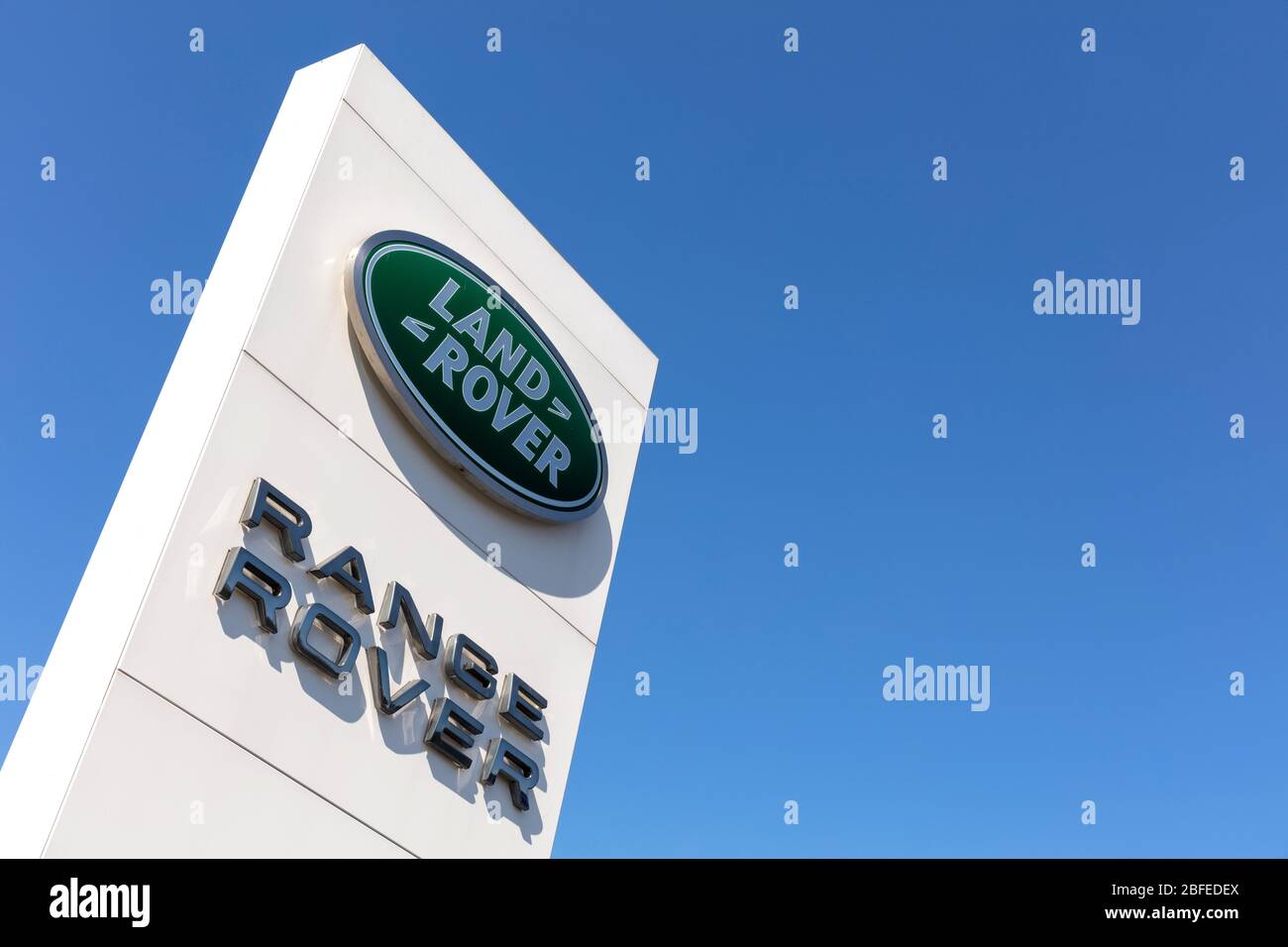 Land Rover/ Range Rover dealership sign against blue sky Stock Photo ...