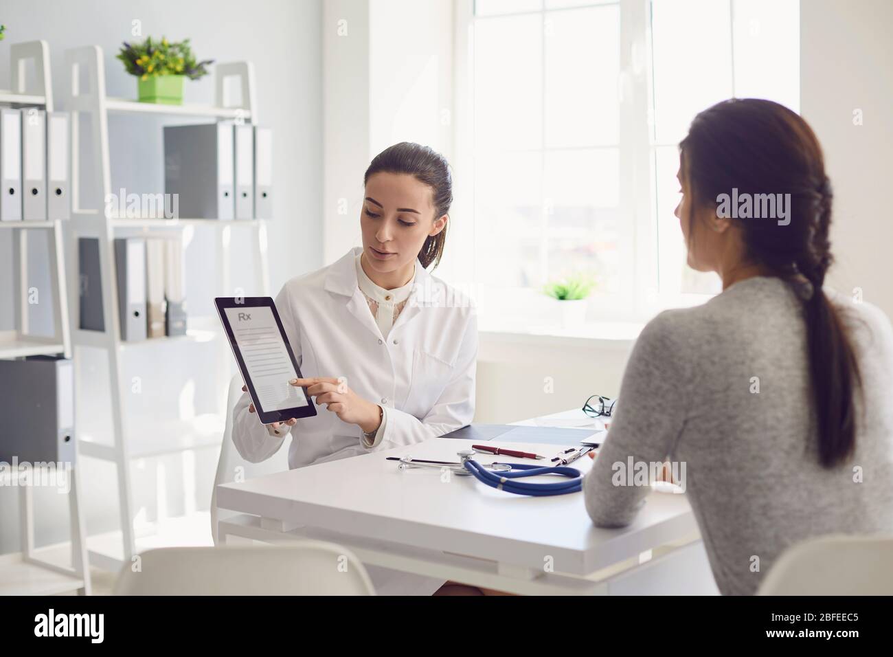 Woman patient visiting female doctor at clinic office. Medical work ...