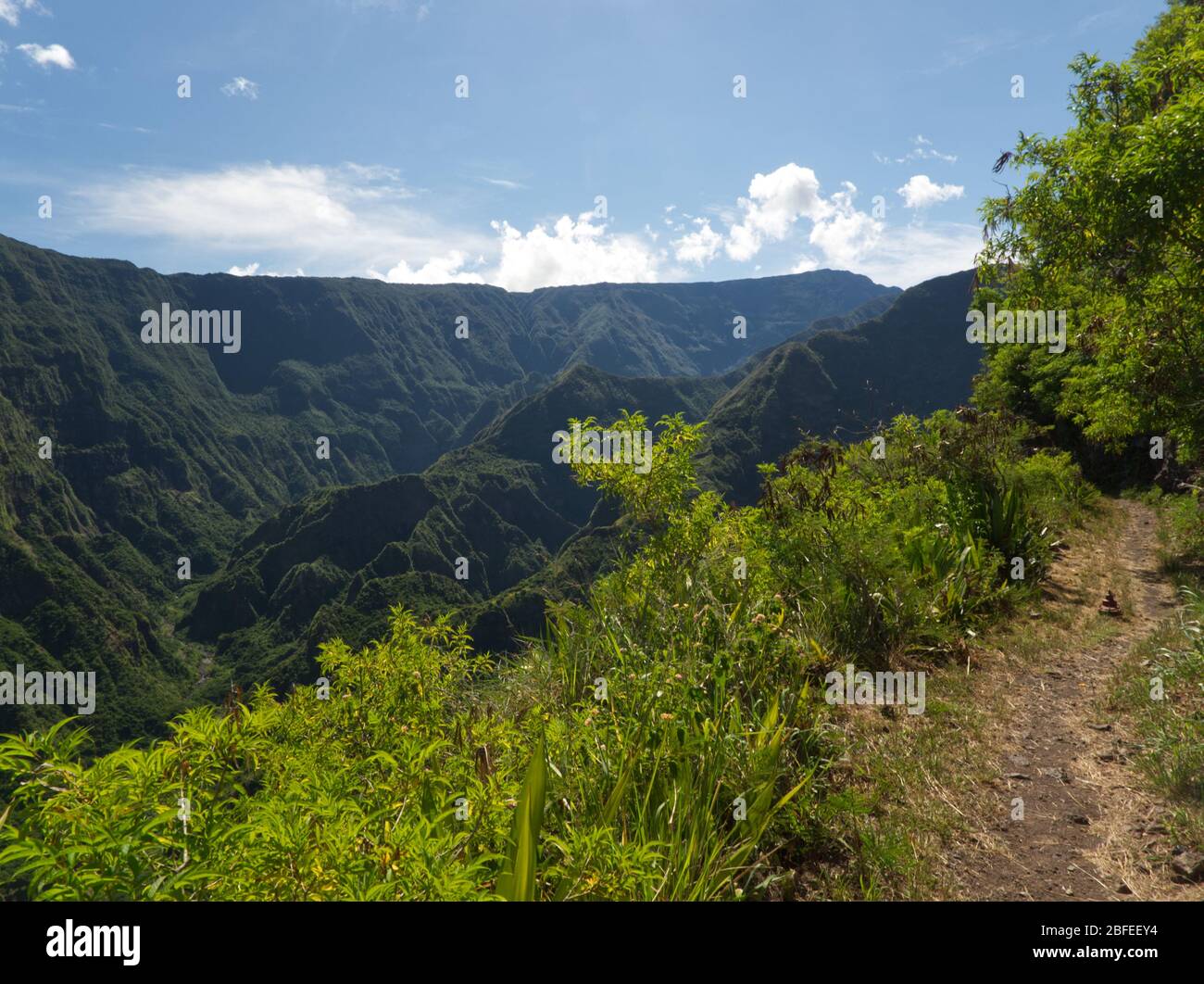 Scenic viewpoint on the path to Mafate with impressive steep mountains ...