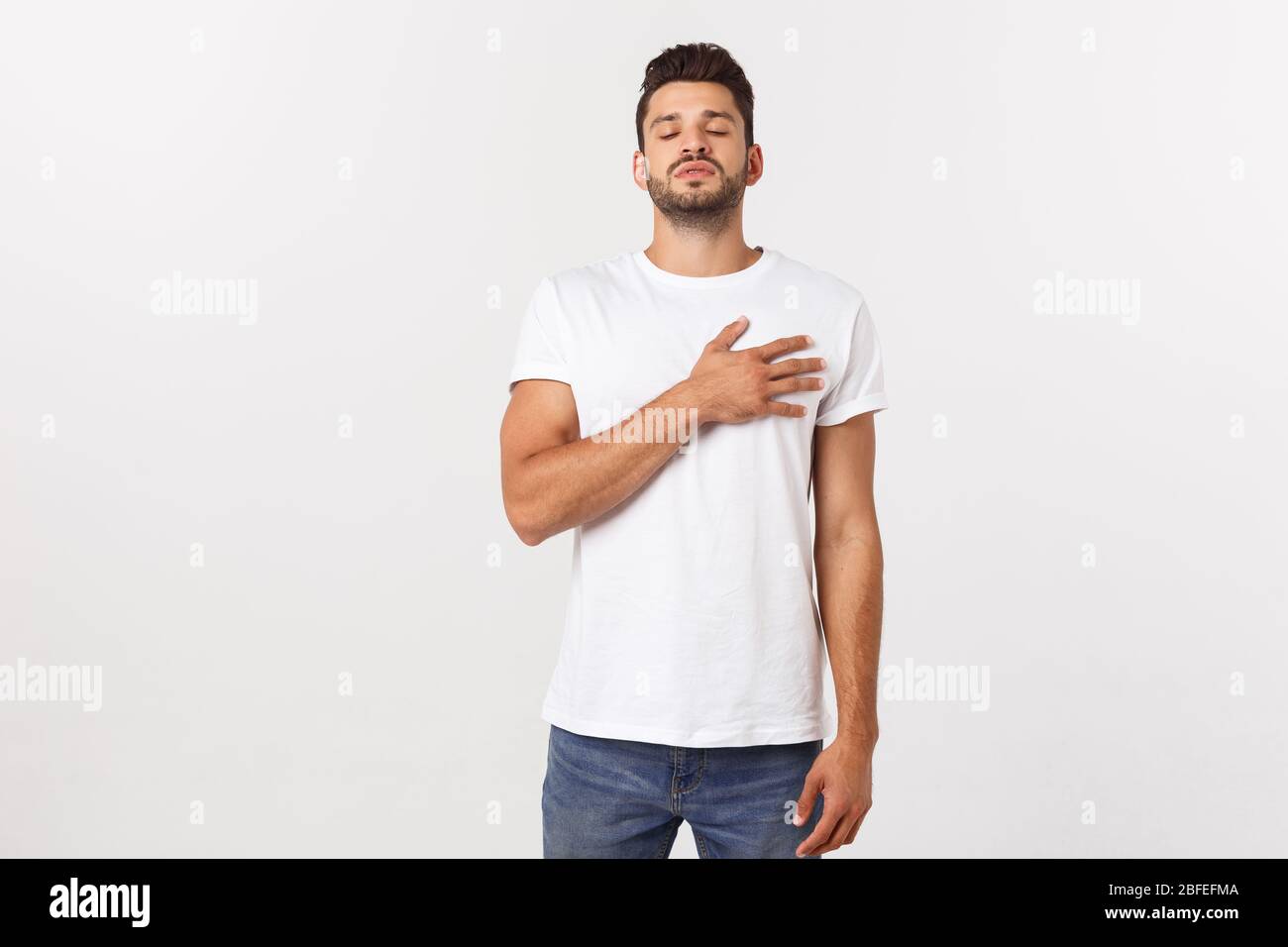 Charming handsome. Handsome young man in casual wear while standing ...