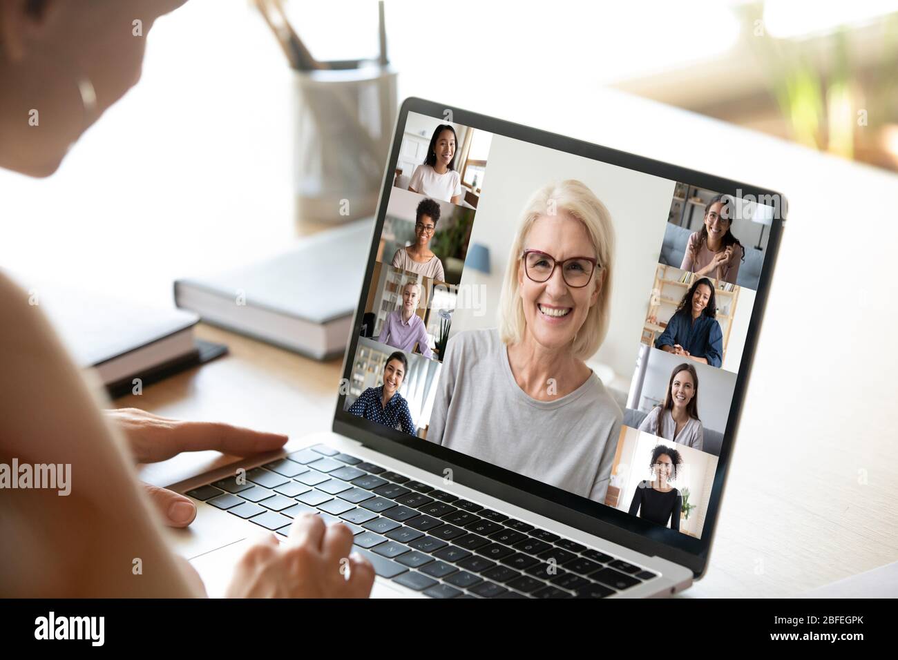Diverse woman involved in group videocall, laptop screen view Stock ...