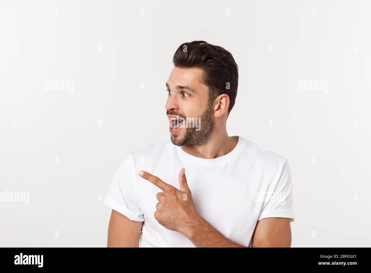 Man pointing showing copy space isolated on white background. Casual ...