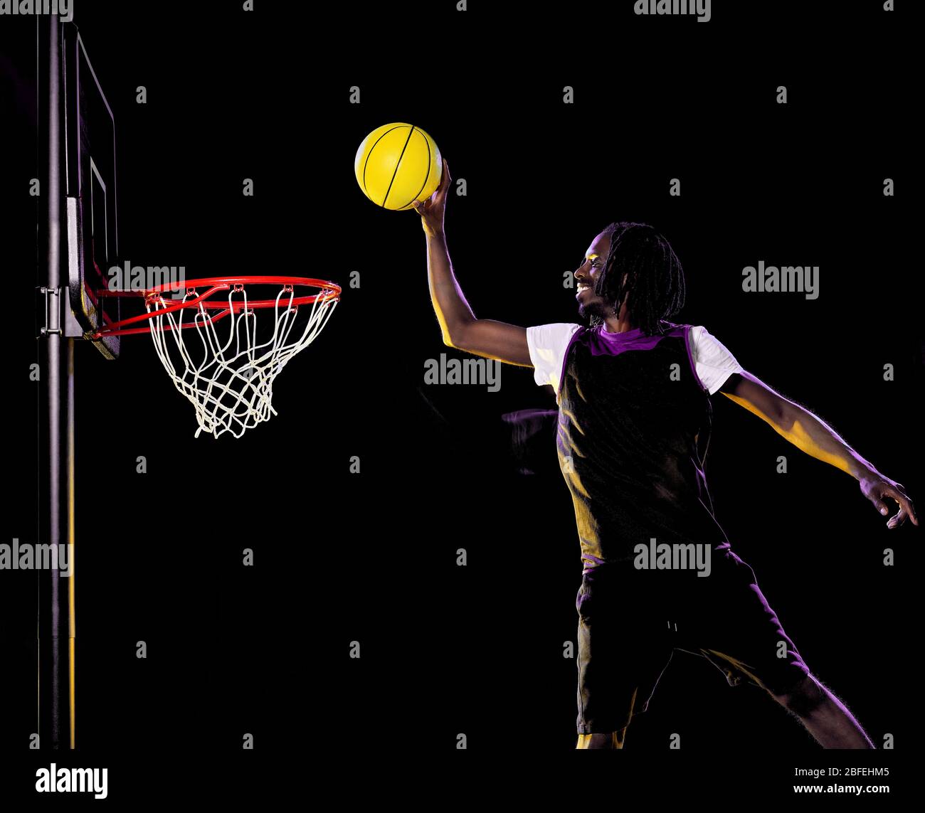 one mature african basketball player man in studio multiple exposure in ...