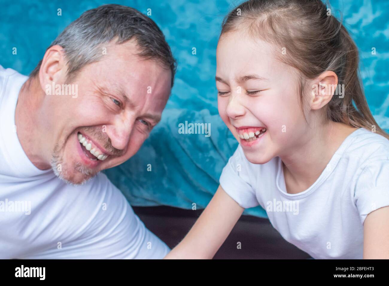 Father and daughter have fun laughing at a joke Stock Photo - Alamy