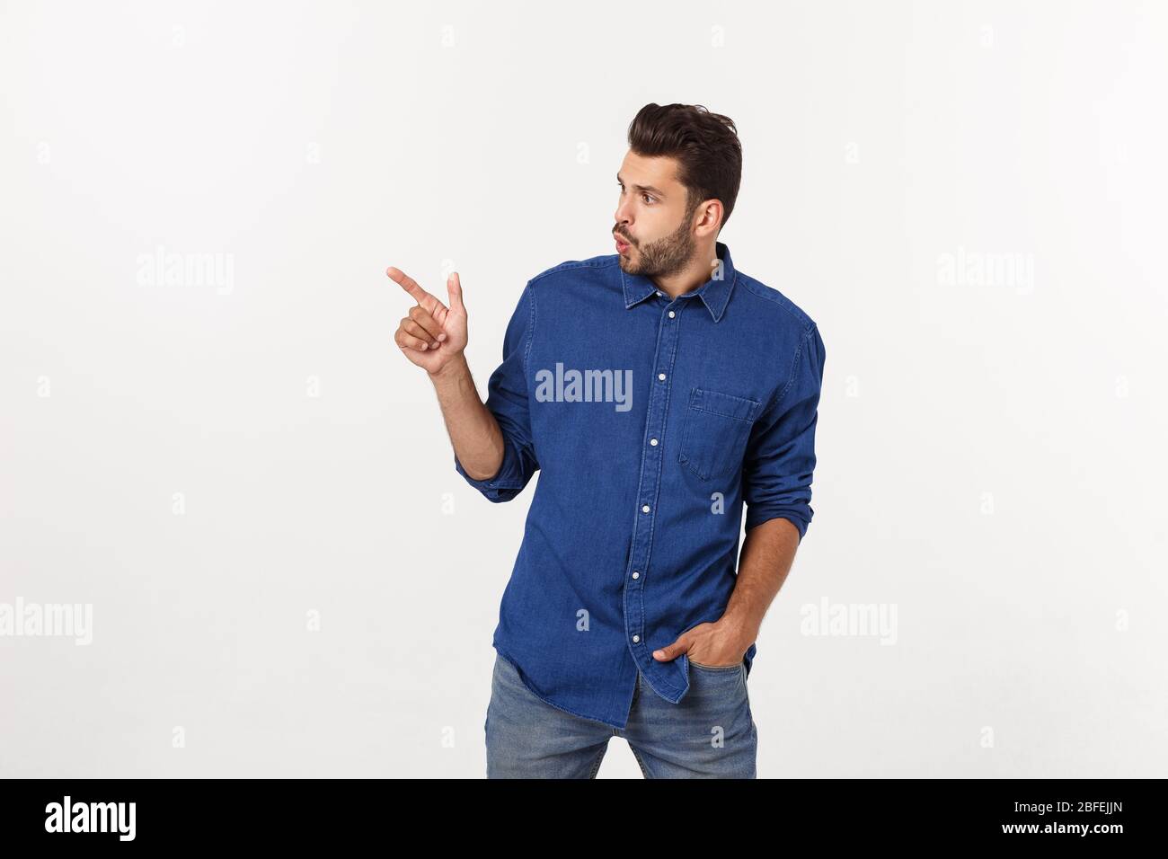 Man pointing showing copy space isolated on white background. Casual ...