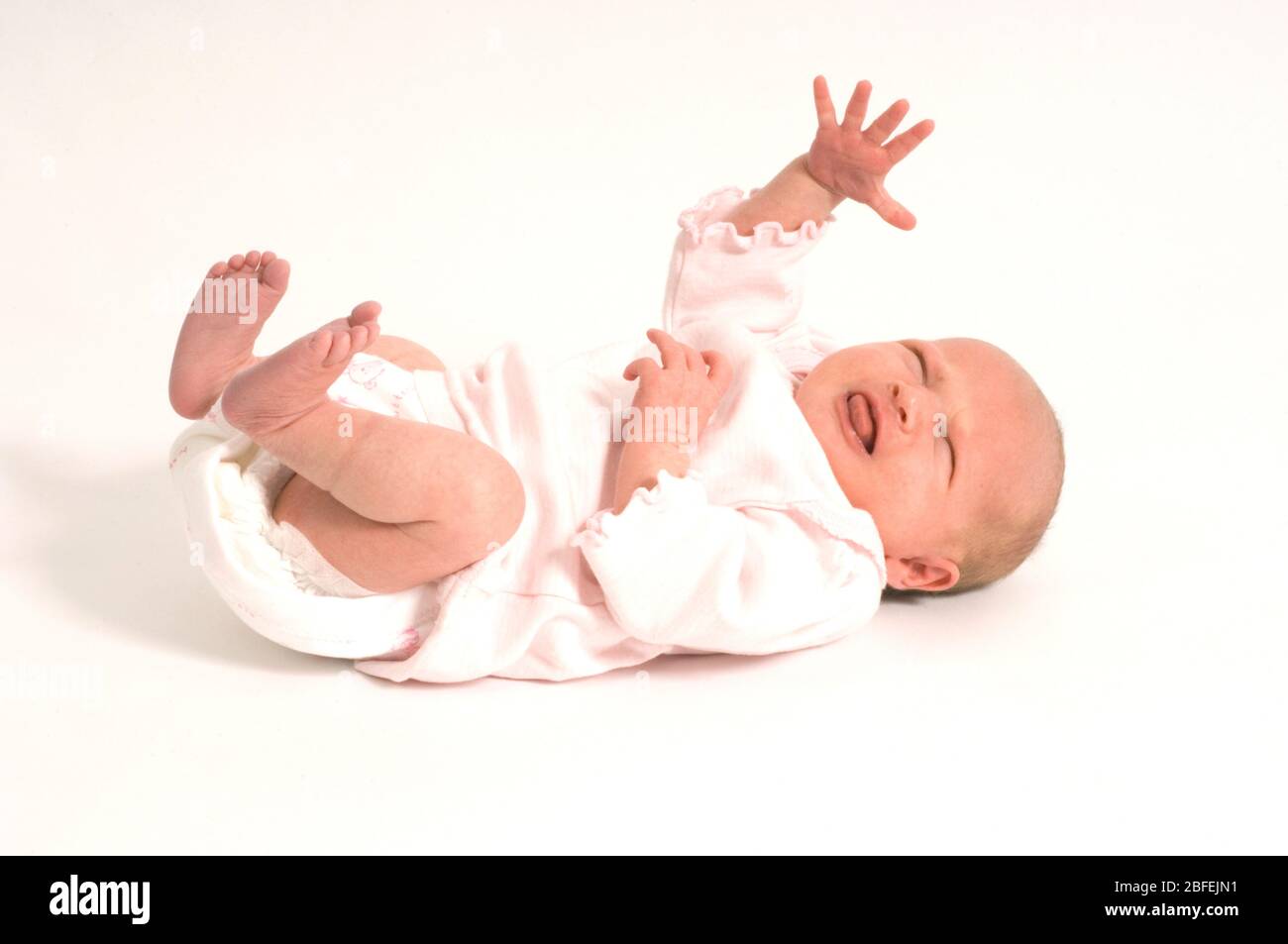Baby girl lying on her back Stock Photo - Alamy