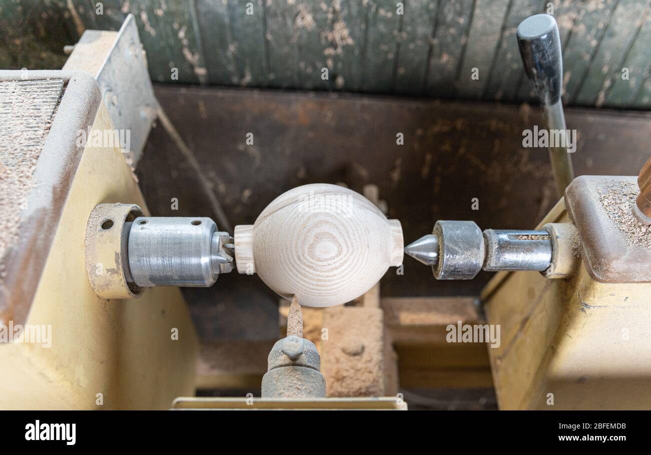 manufacture round wooden handles on lathe in joinery Stock Photo - Alamy