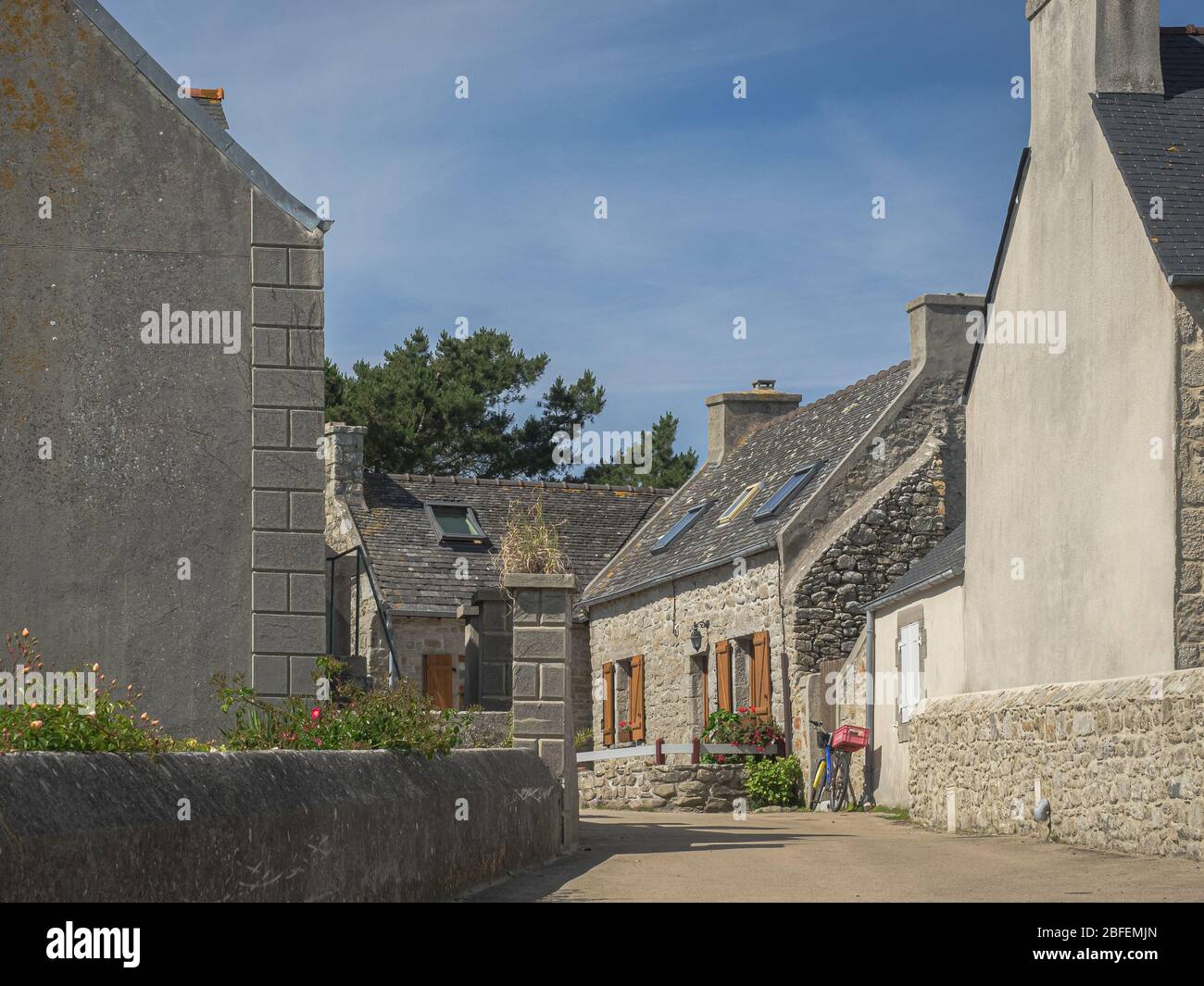 Small village scene with traditional stone houses, flowers, and a ...