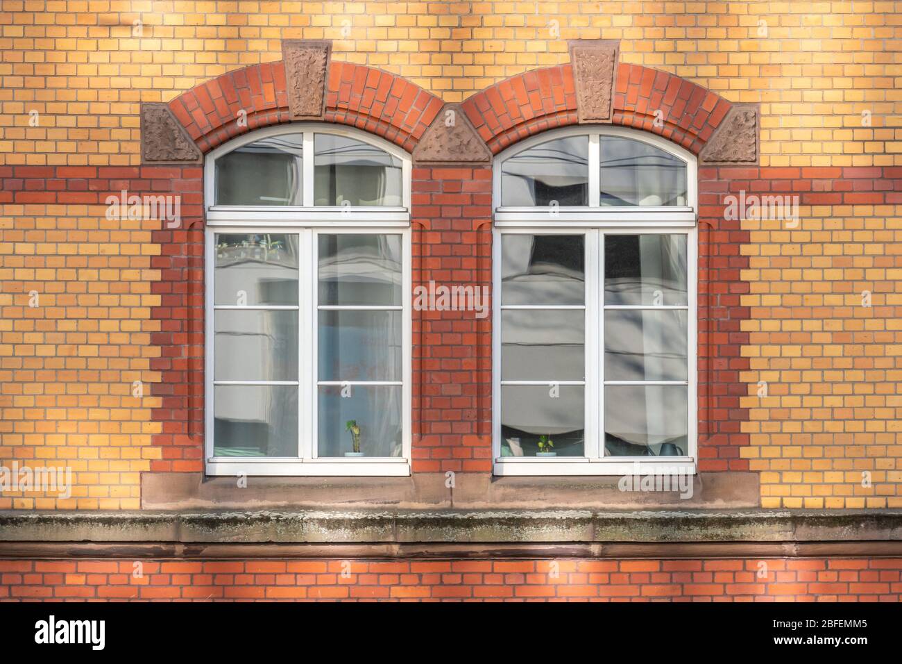 Old building facade red and beige dutch clinker surrounding windows as ...