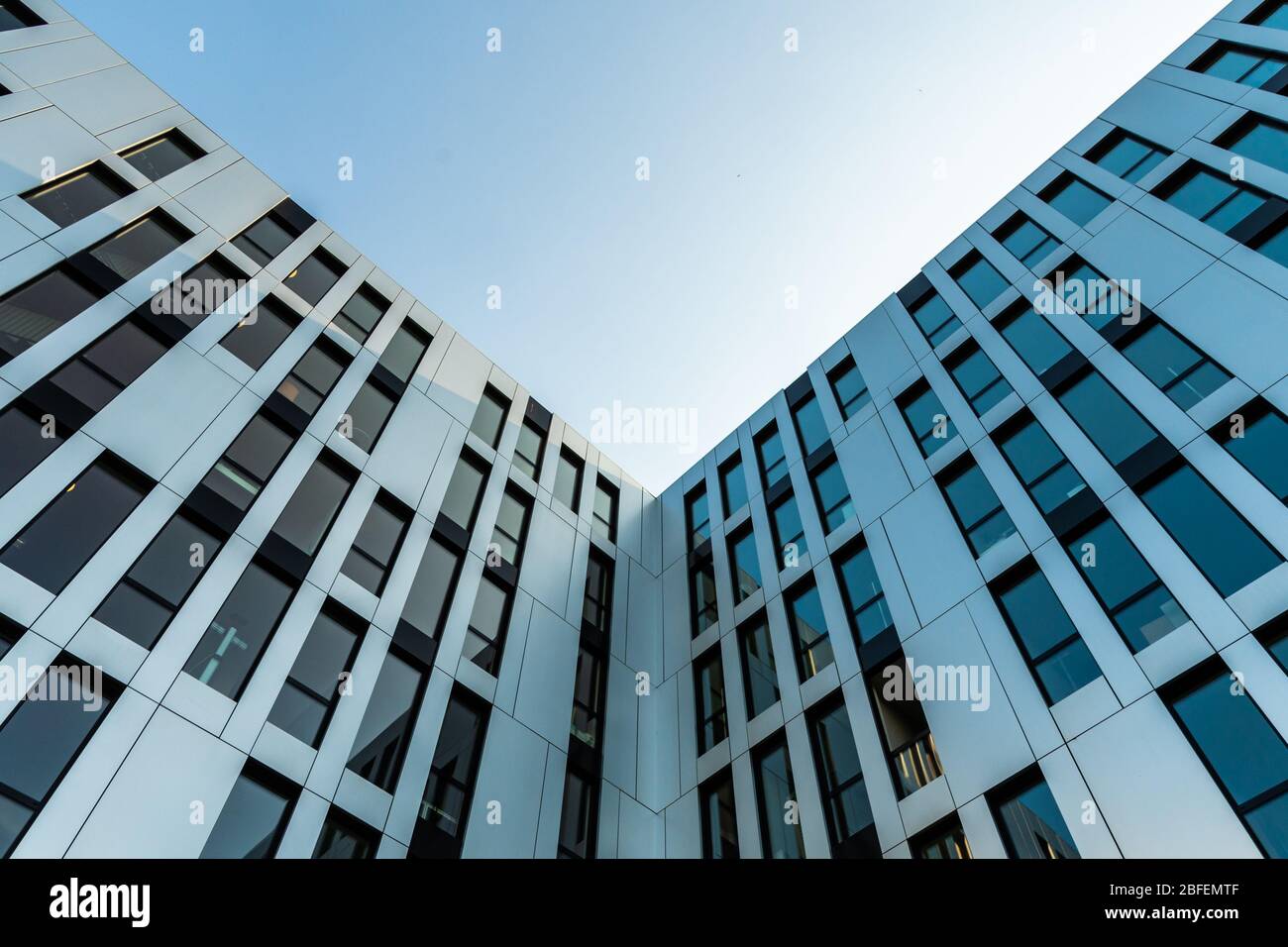 Stainless steel and mirrored glass facade of modern office building in ...